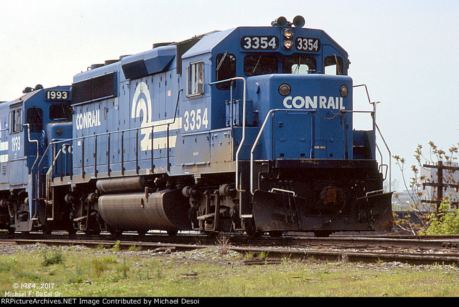 Conrail GP-40-2 #3354 has just crossed the Lehigh River and is about to enter the yard with an ...